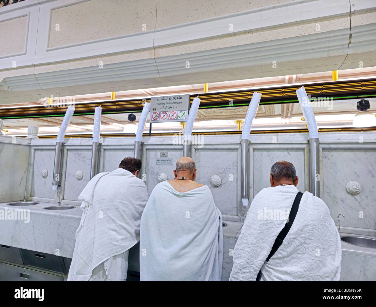Mecca, Saudi Arabia, June 8 2024: pilgrims drinking from Zamzam well ...