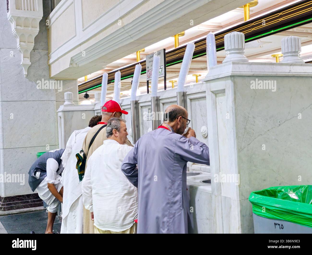 Mecca, Saudi Arabia, June 8 2024: pilgrims drinking from Zamzam well ...