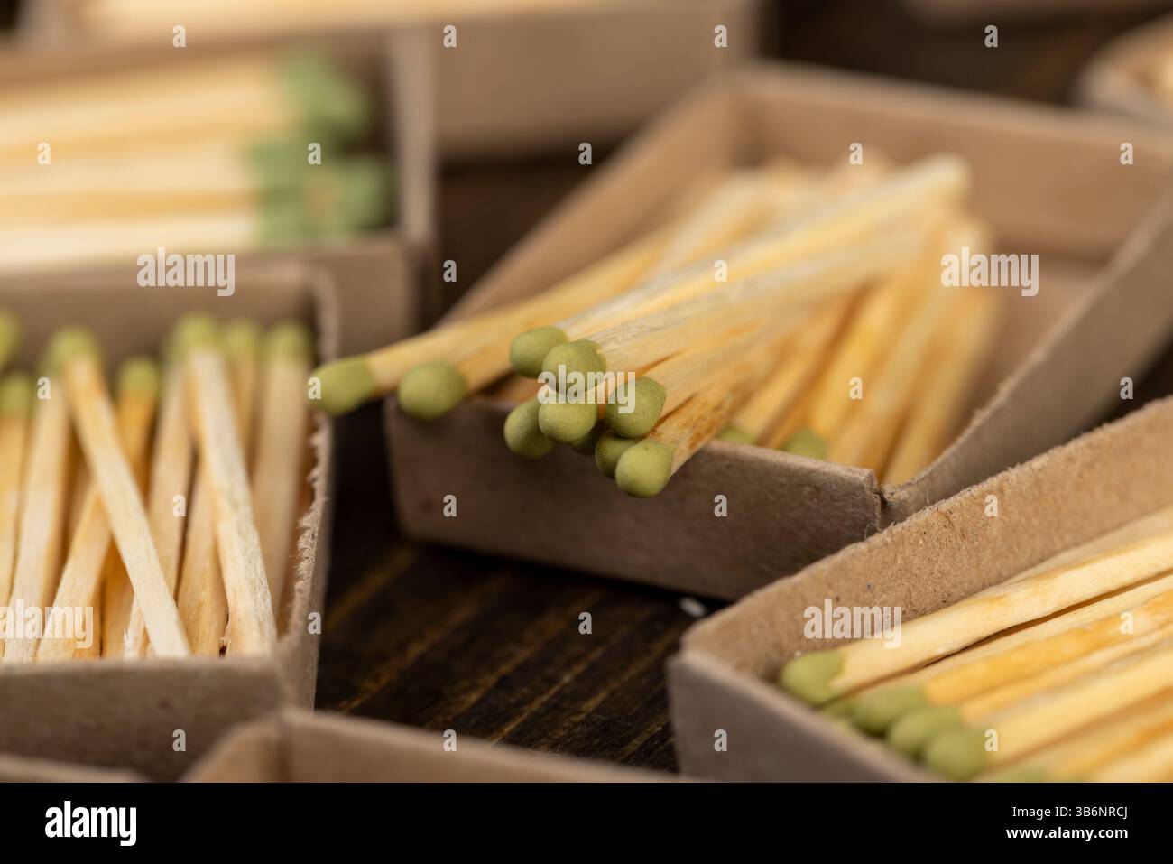 green wooden matches poured into cardboard boxes, close up Stock Photo ...