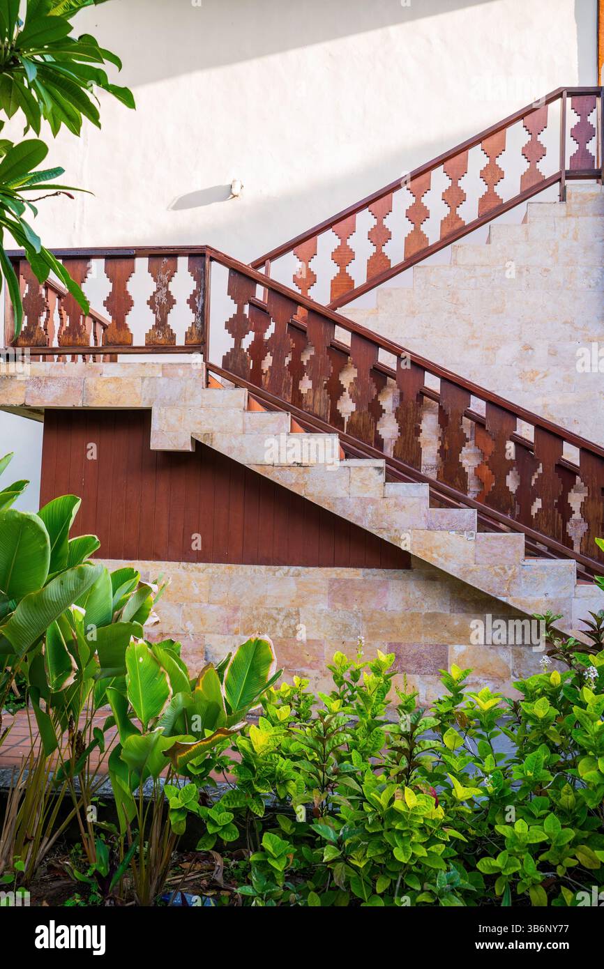 Elegant stone staircase with ornate wooden balustrades in Balinese ...