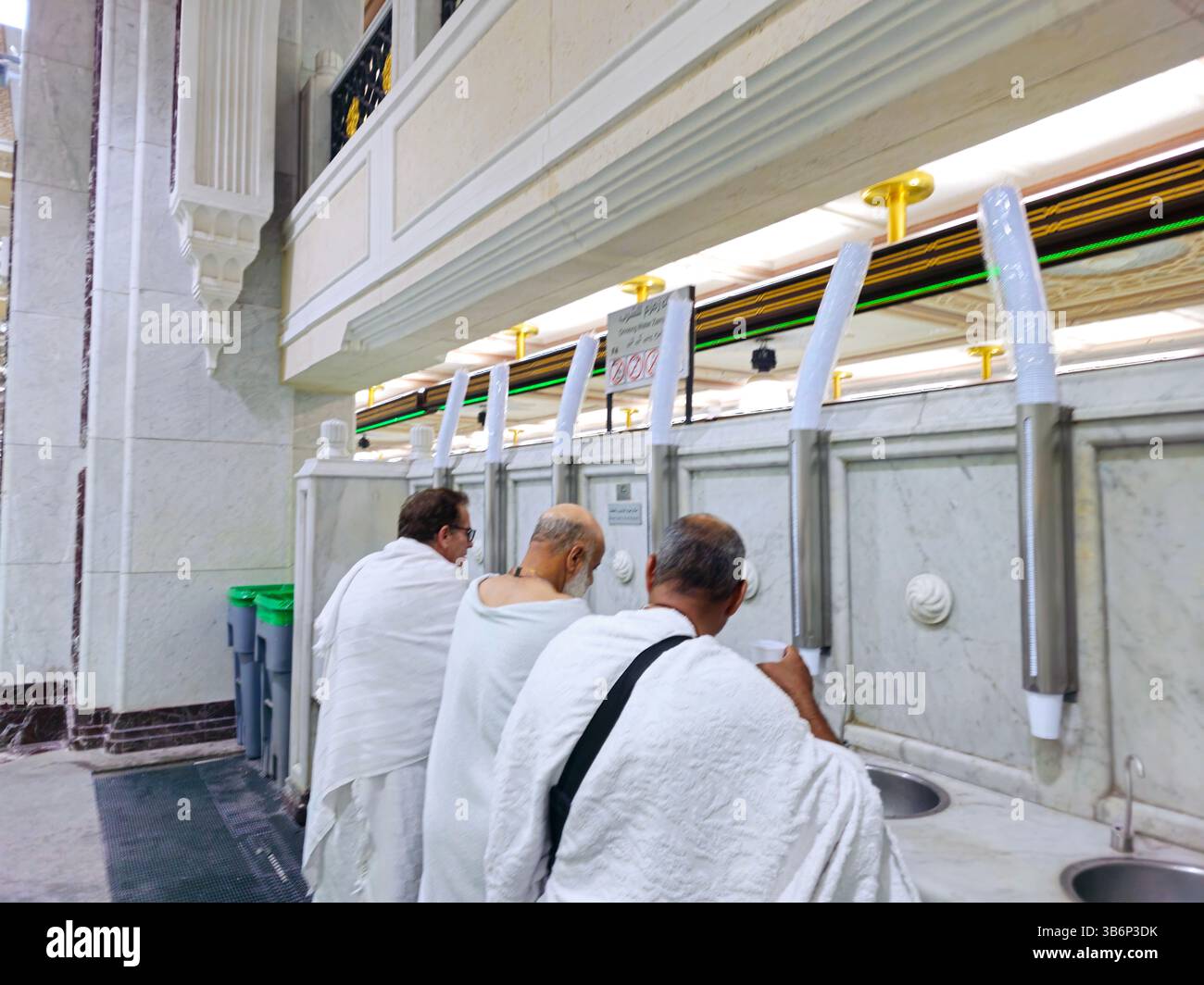 Mecca, Saudi Arabia, June 8 2024: pilgrims drinking from Zamzam well ...