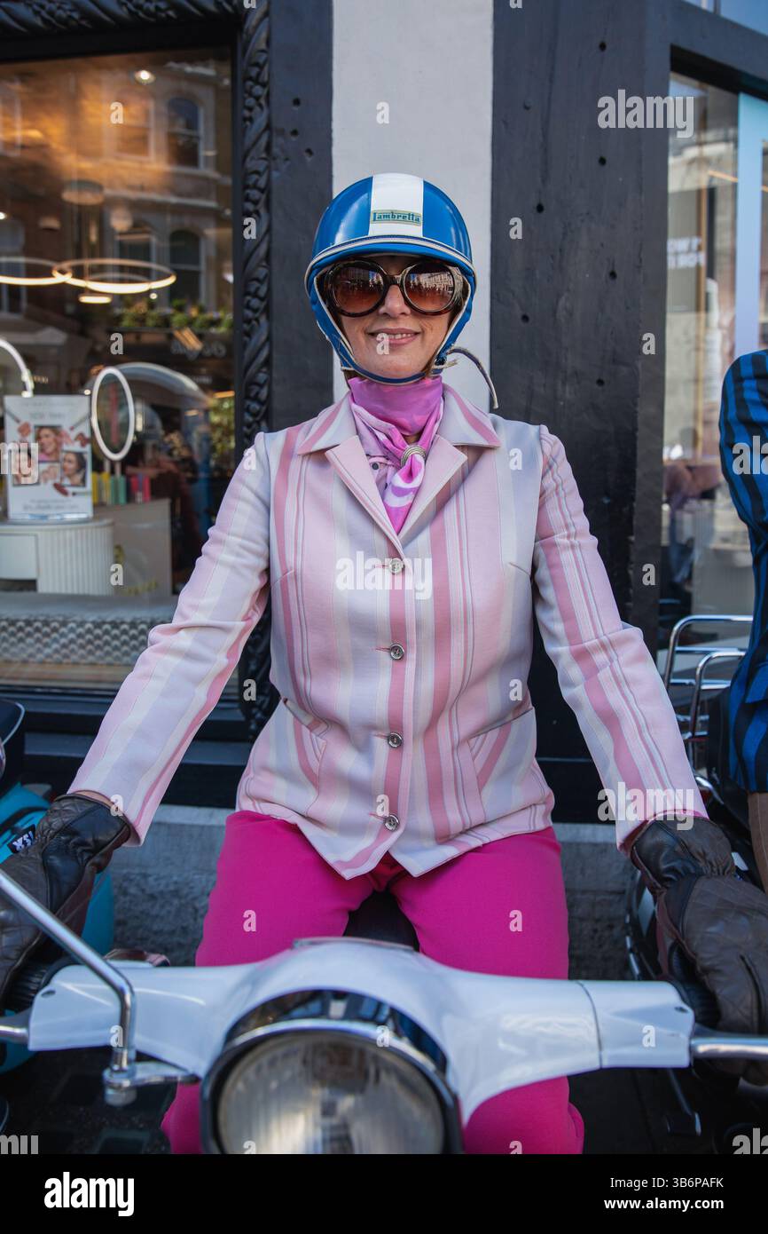 A Mod pose's for a photograph whilst sitting on a classic scooter. Mods ...