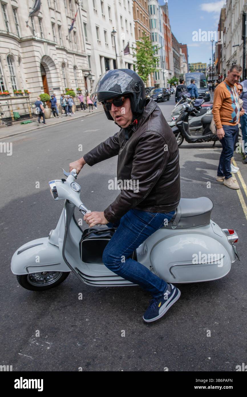 London, UK. 03rd May, 2025. A Mod rides a classic scooter through a ...