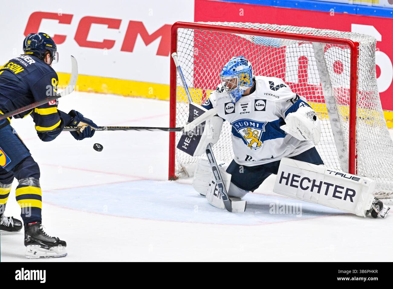 L-R Leo Carlsson (SWE) and goalkeeper Juuse Saros (FIN) in action ...