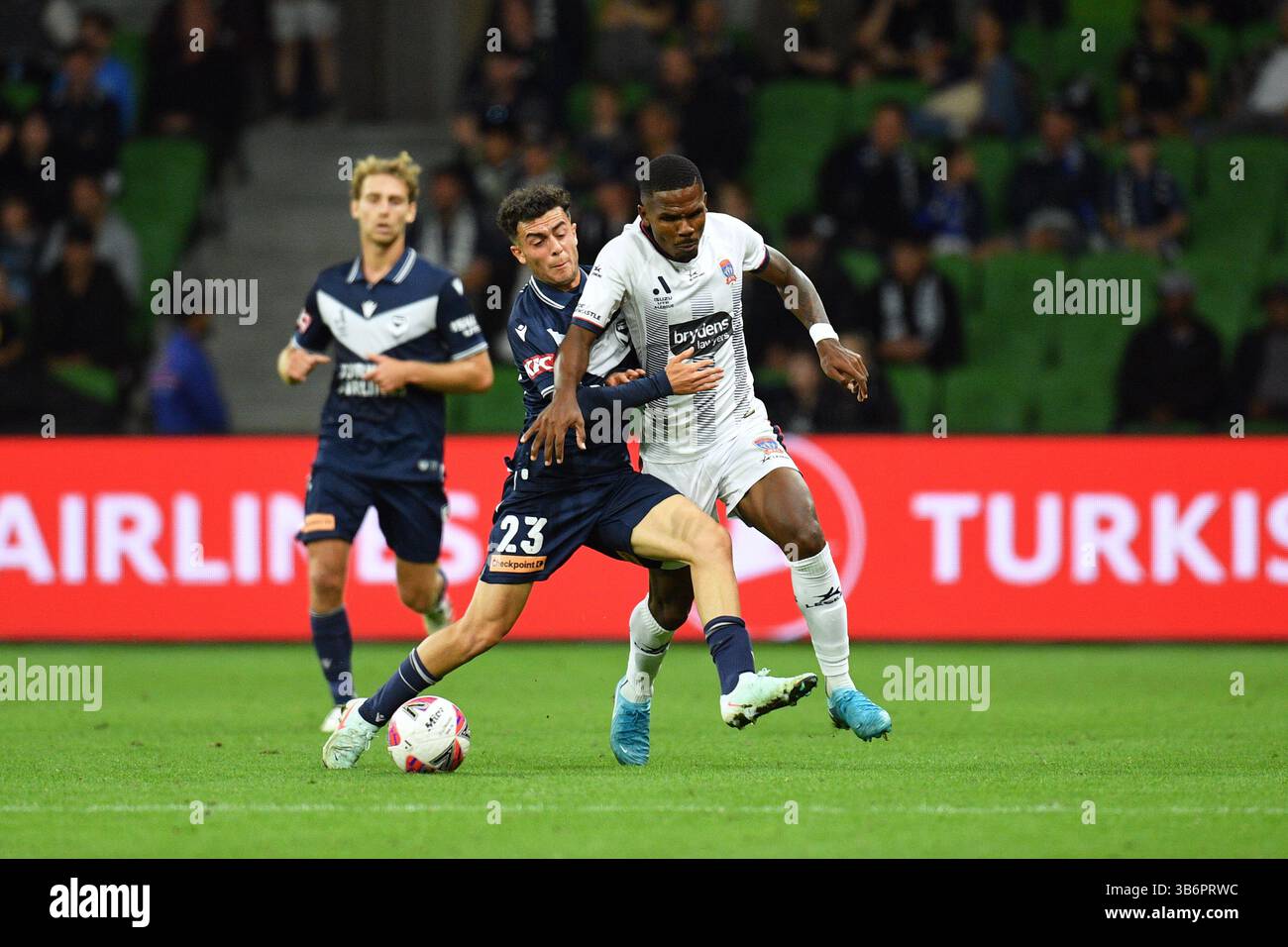 MELBOURNE, AUSTRALIA. 4th May 2025. Pictured: Newcastle United Jets forward Wellisol is held by ...
