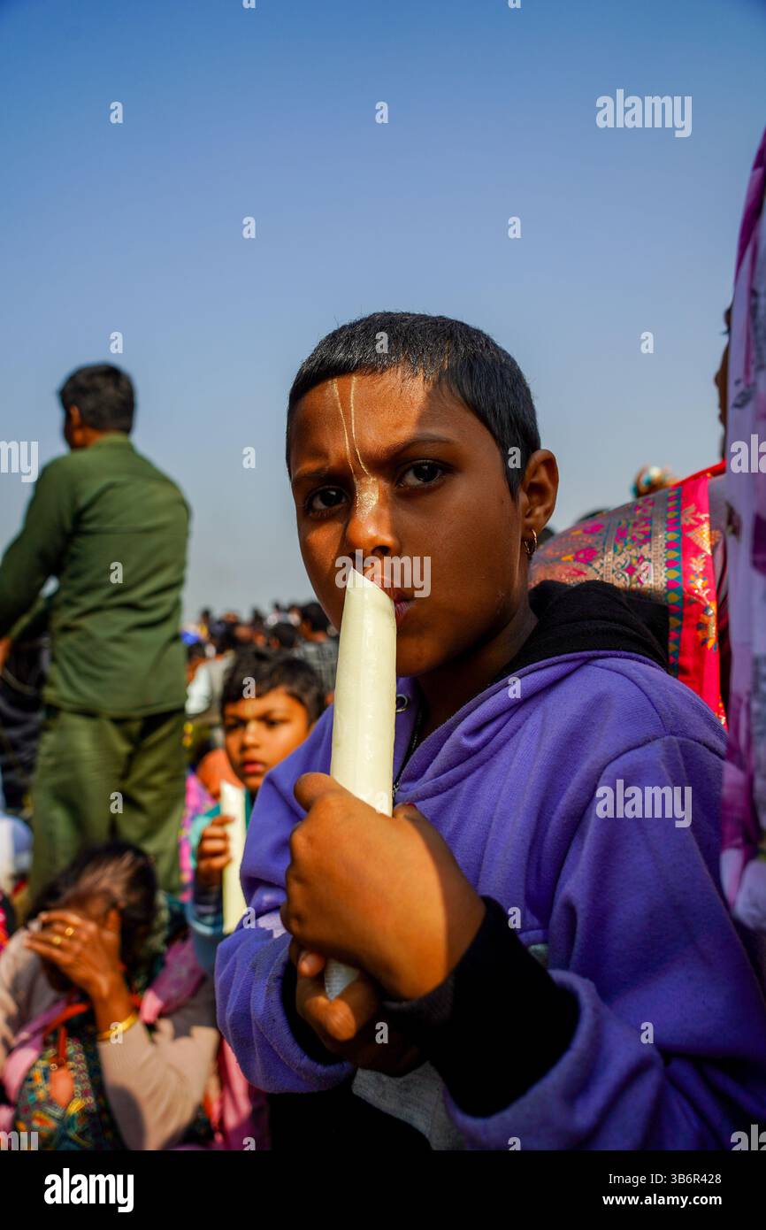 An Indian girl with Vaishnav tilak on forehead eating ice candy in a ...