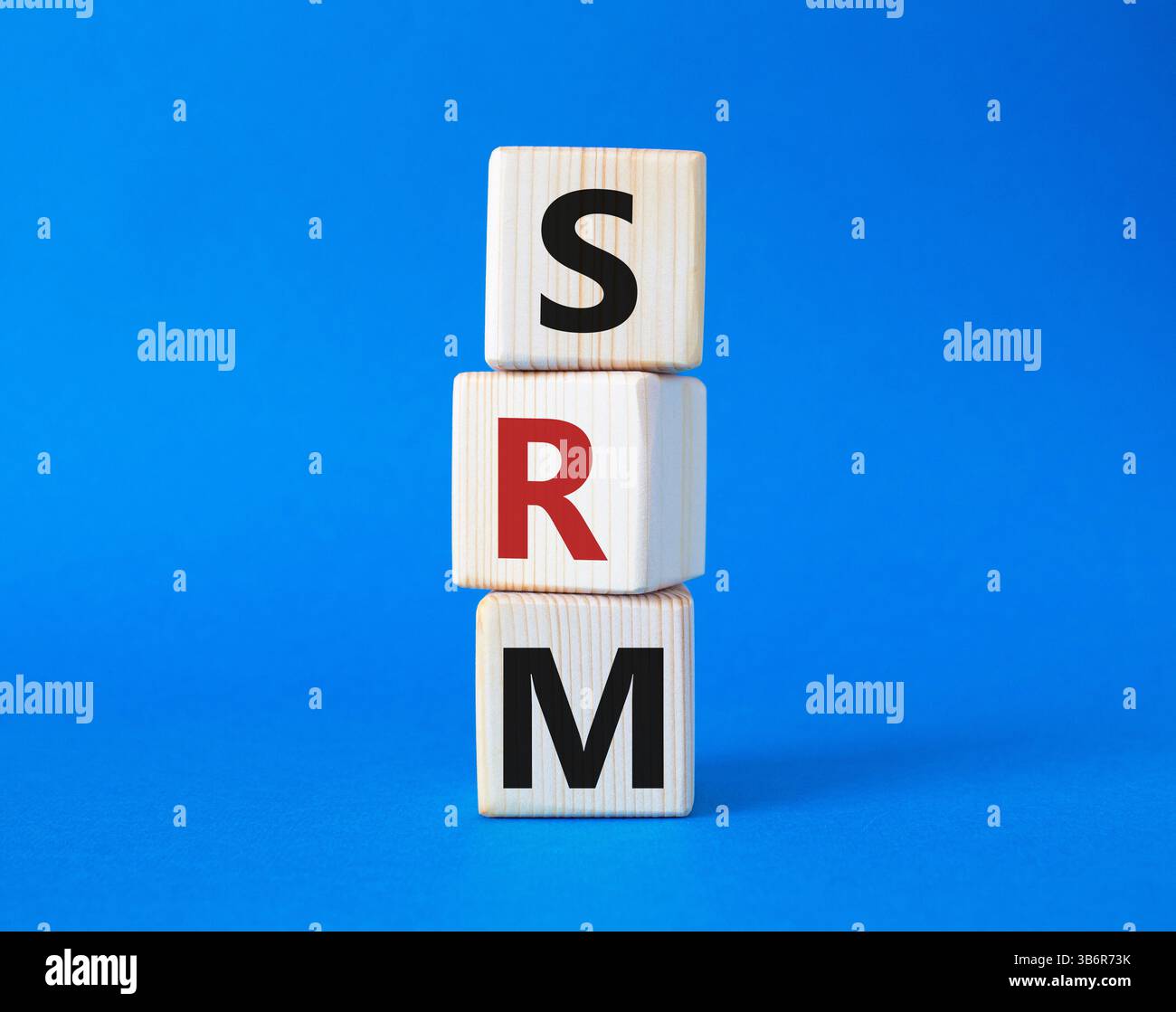 SRM - Sustainability Risk Management symbol. Wooden cubes with word SRM. Beautiful blue ...