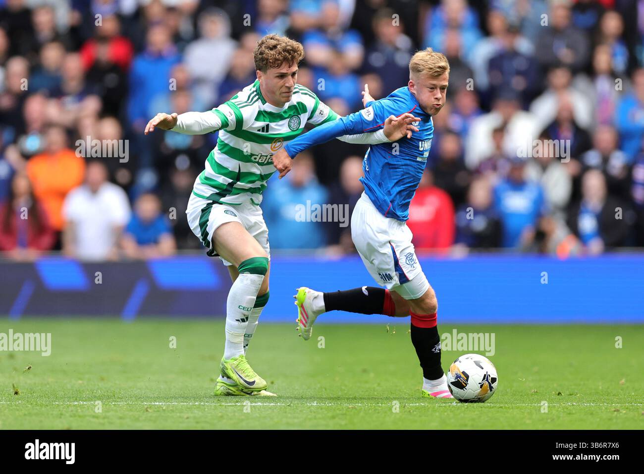 Celtic's Arne Engels (left) and Rangers' Connor Barron battle for the ...