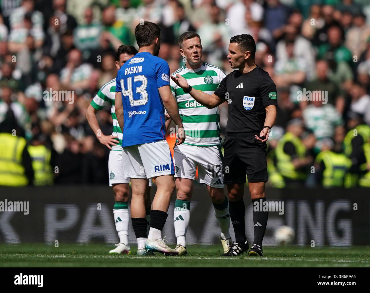 Referee Nick Walsh speaks with Rangers' Nicolas Raskin after his goal ...