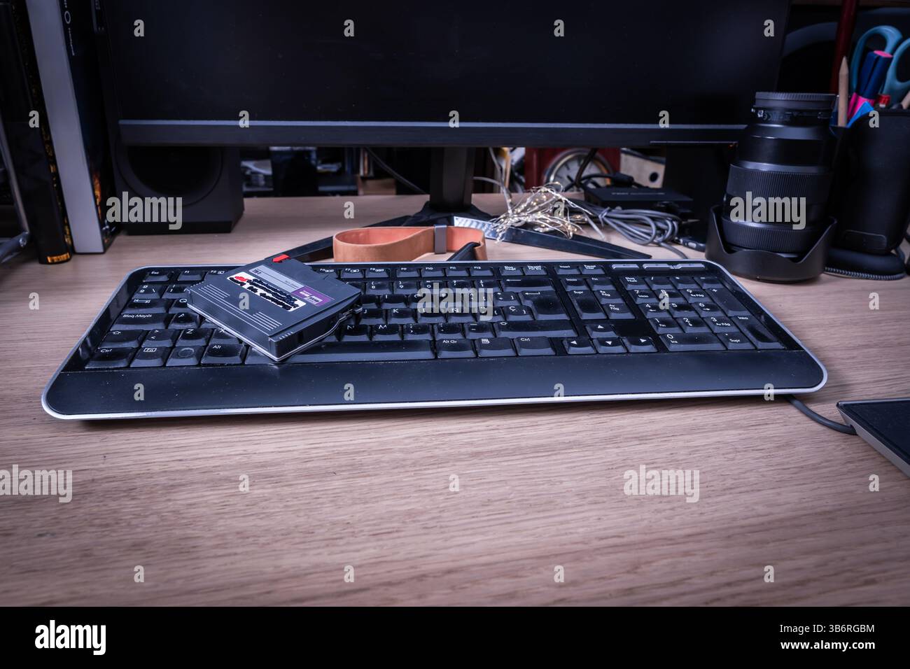 Vintage data cartridge resting on contemporary keyboard, highlighting ...