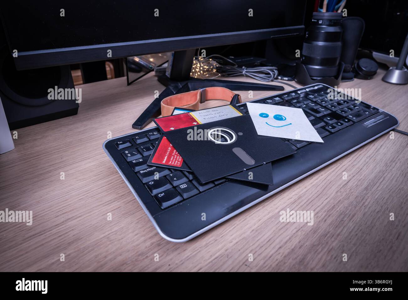 Vintage floppy disks scattered near worn keyboard, representing digital ...