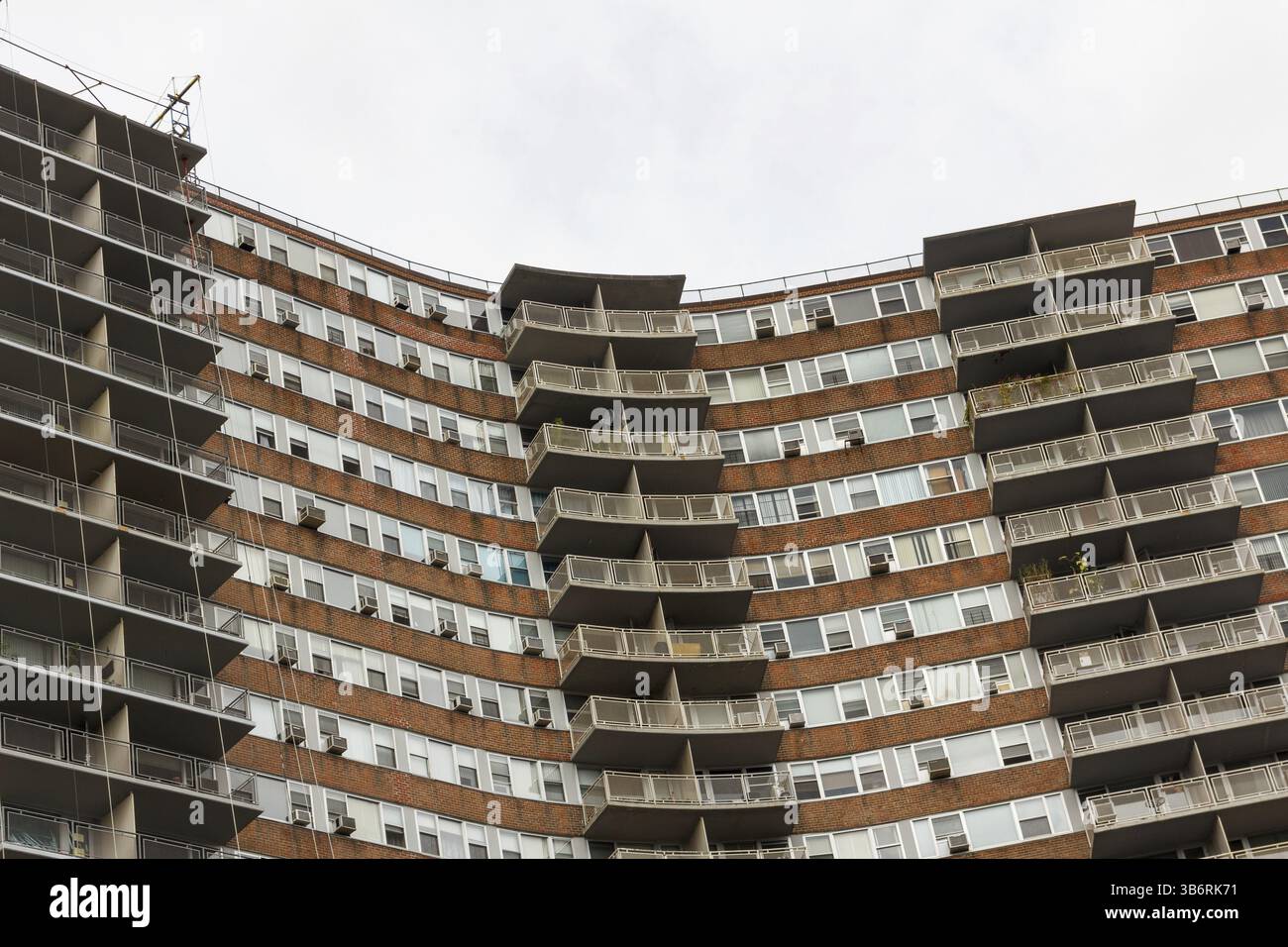 Red brick aparment building facade with rows of balconies in New York ...