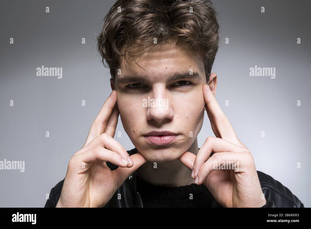 Wide angle. Studio shot. Young caucasian guy model in black clothes ...