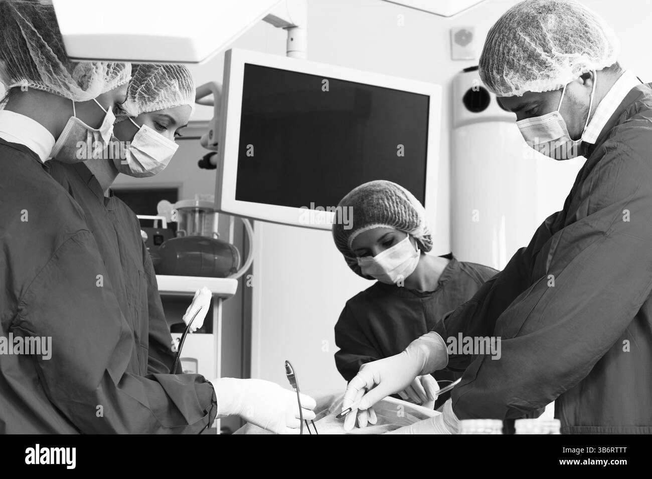 Surgery team operating in a surgical room Stock Photo - Alamy