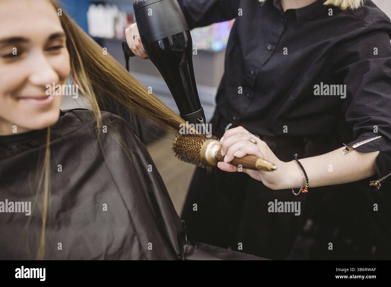 Portrait of happy woman at the hair salon. Professional hair styling ...