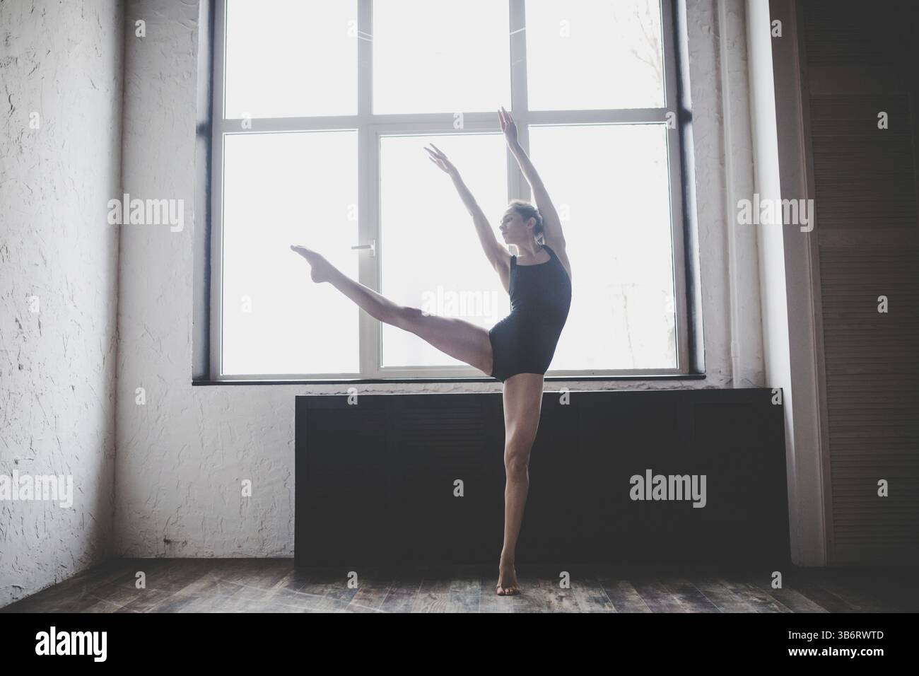 Plasticity slim woman dancing near window. Professional dancer enjoy ...