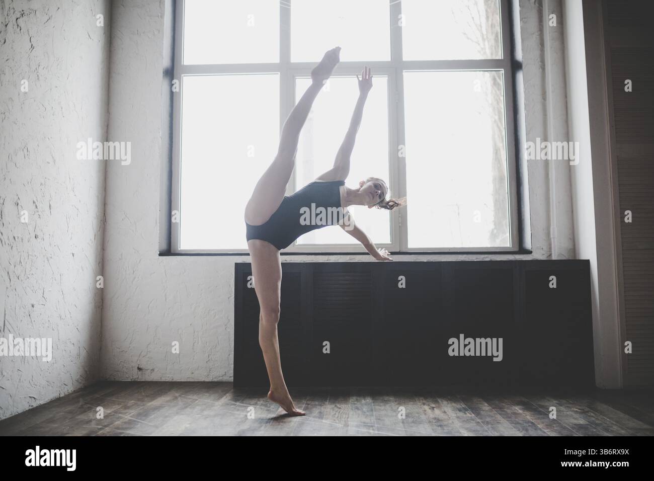 Plasticity slim woman dancing near window. Professional dancer enjoy ...