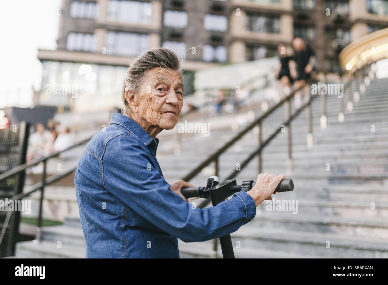 Active old woman riding electric scooter. Retired lady uses ...