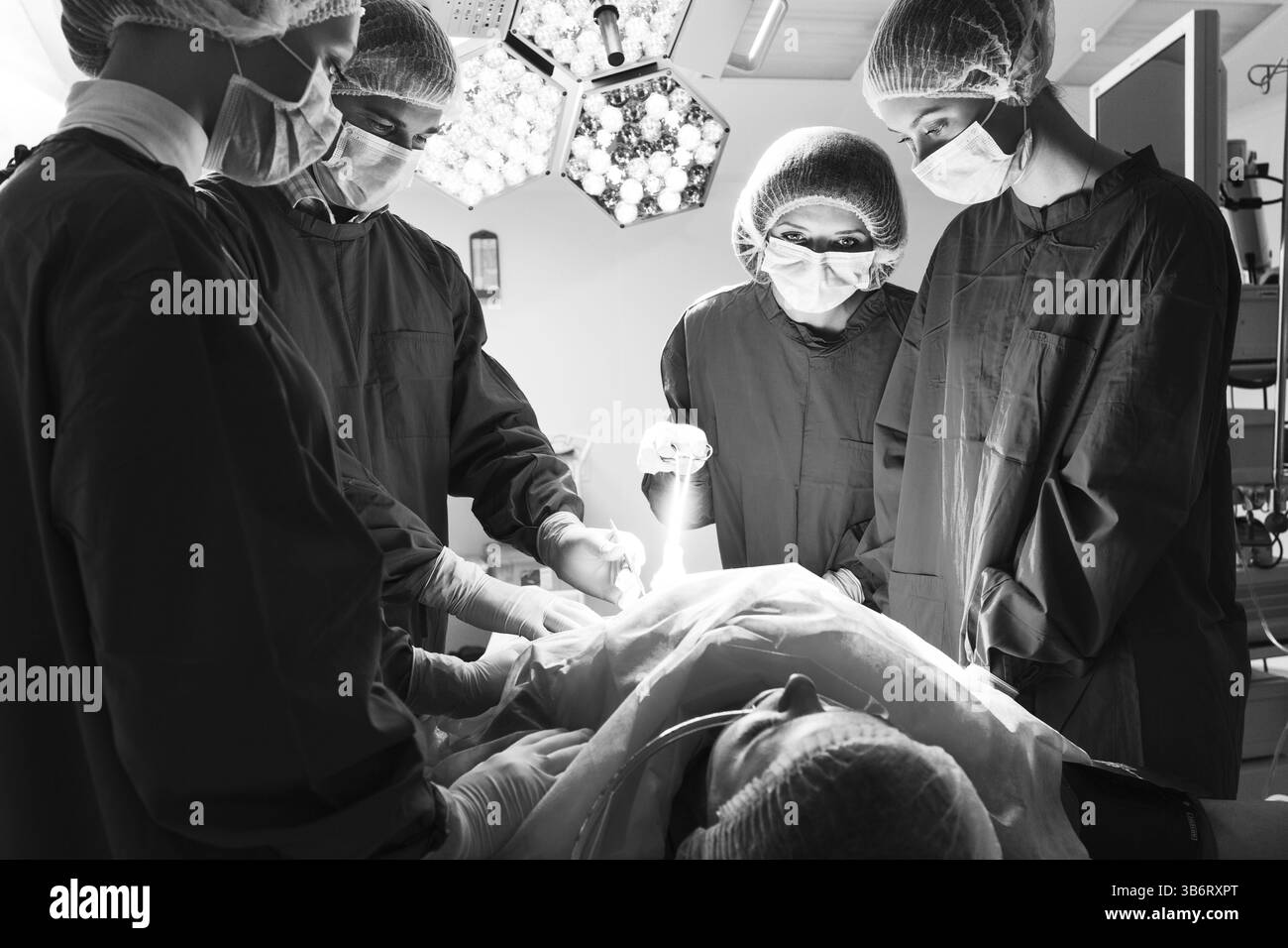 Surgery team operating in a surgical room Stock Photo - Alamy