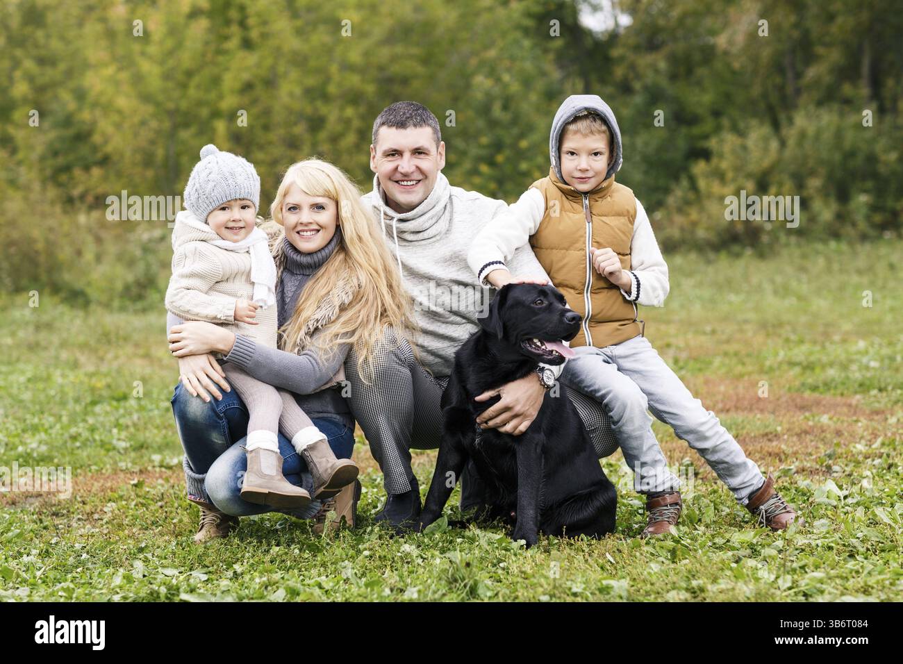 Happy family with dog on nature Stock Photo - Alamy