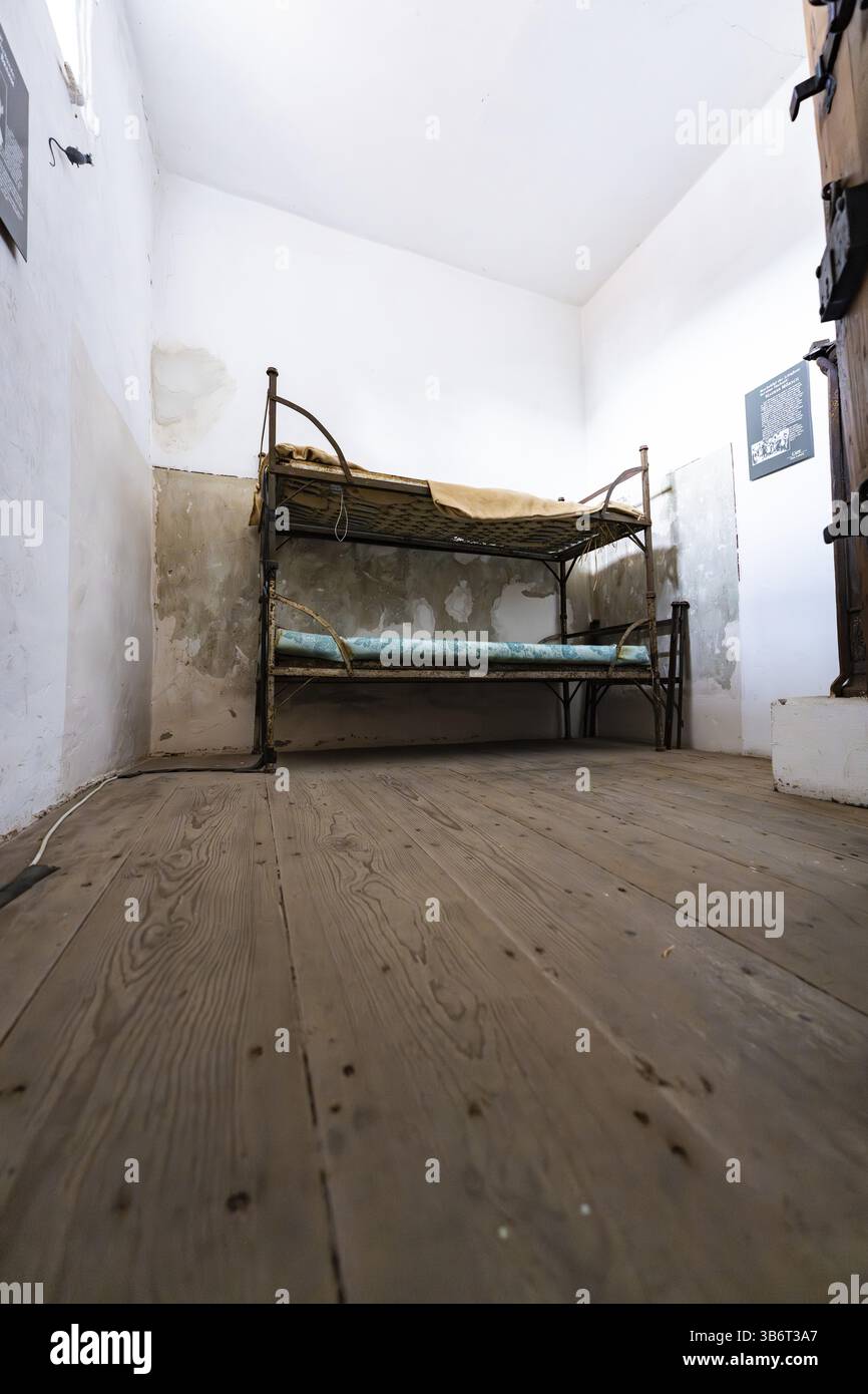 Simple room with bunk bed, wooden floor and white walls, looks spartan ...