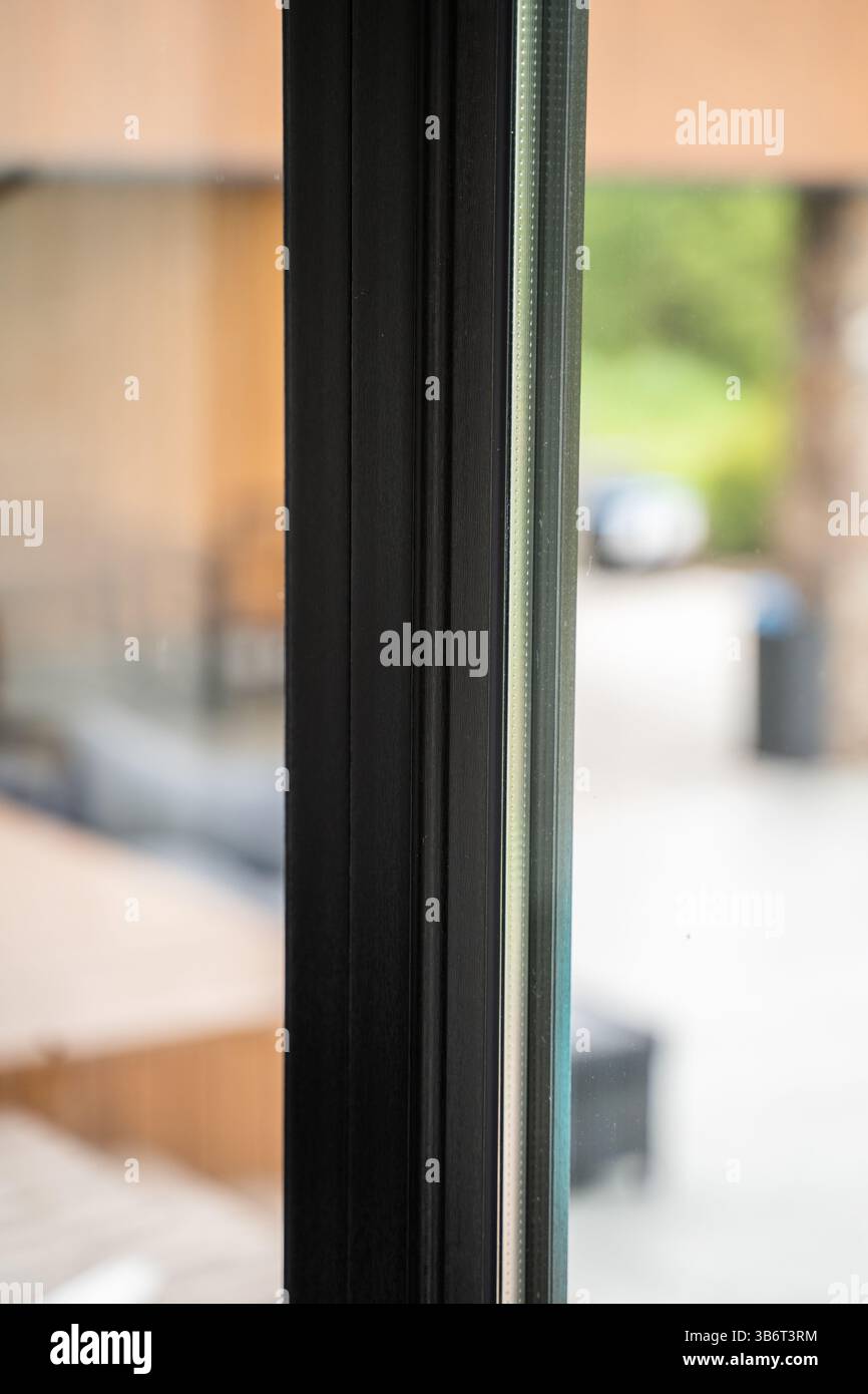 Wide architectural frame shot of black aluminum windows with layered ...