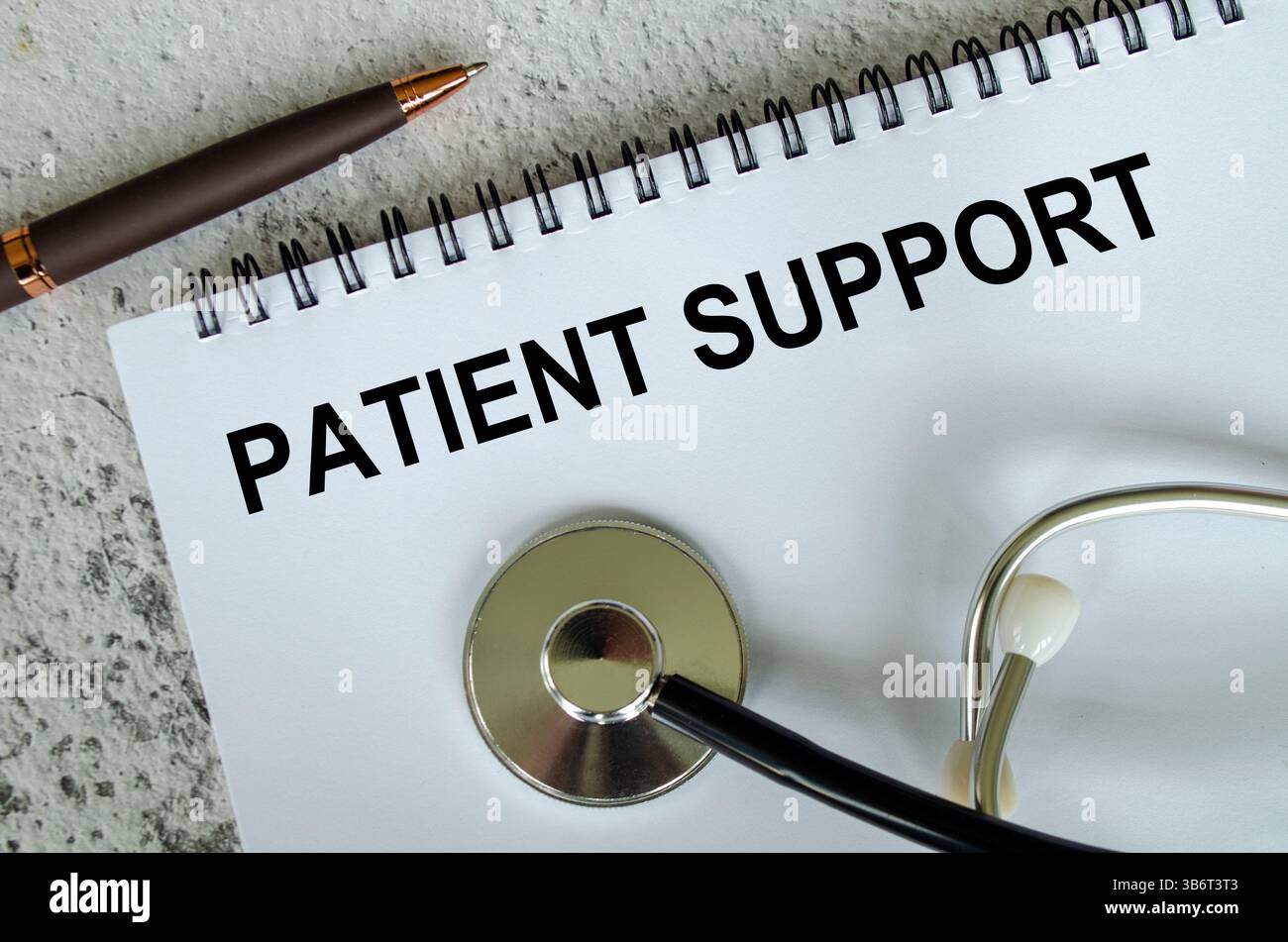 Top view of Patient Support text on white paper notepad with ...