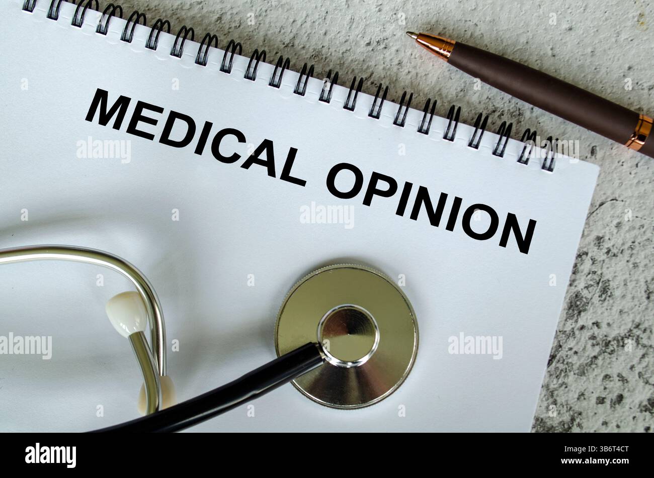 Top view of Medical Opinion Text on white paper notepad with ...