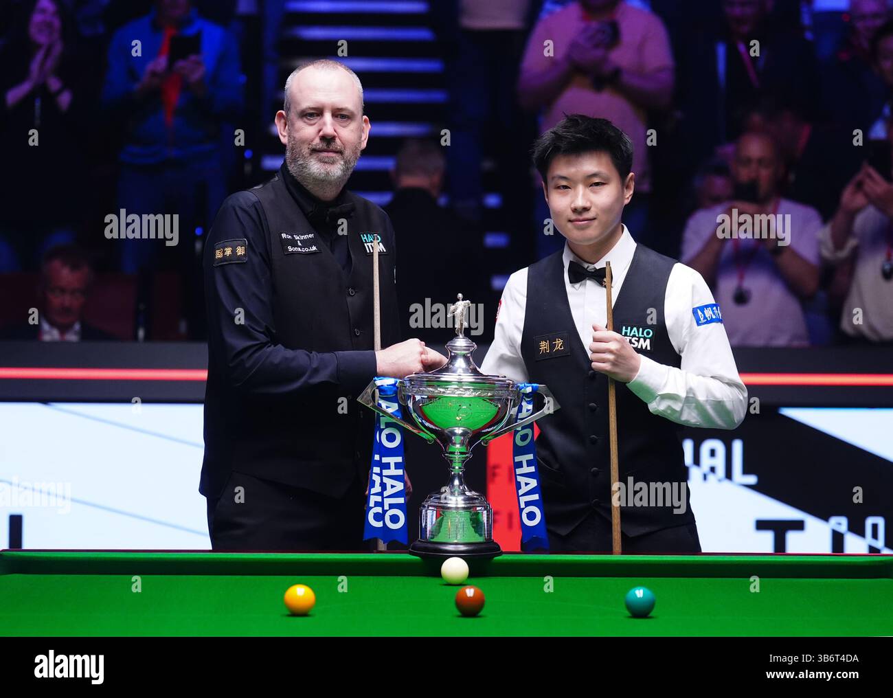 Mark Williams and Zhao Xintong pose with the trophy prior to the Final ...