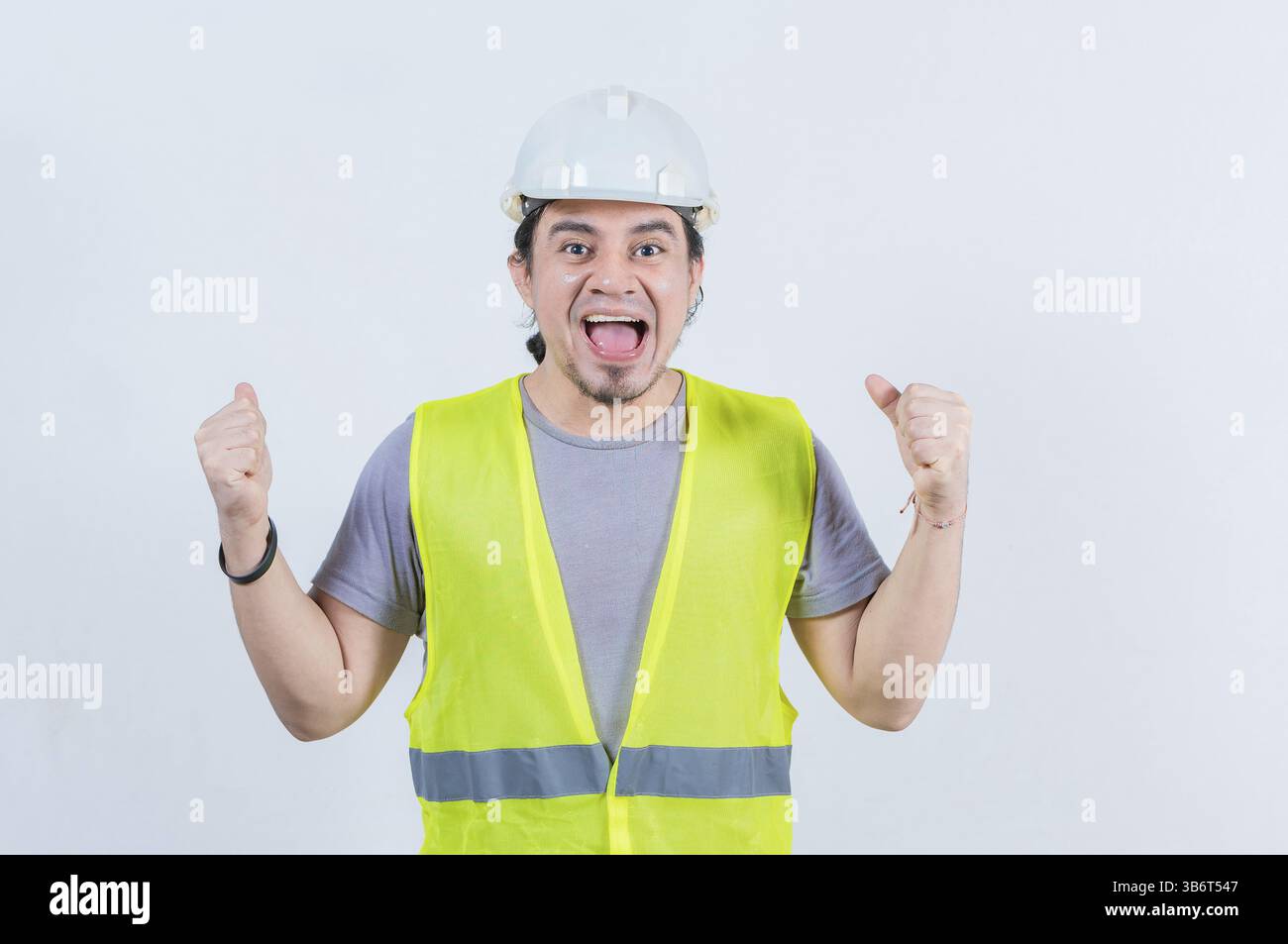 Happy engineer celebrating on isolated background. Excited engineer ...