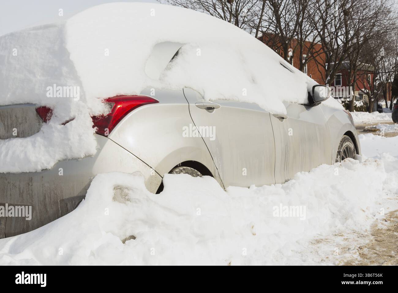 Rear and side view of parked silver car covered with thick blanket of ...