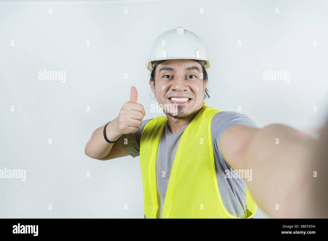 Self portrait of smiling engineer gesturing OK. Handsome engineer ...