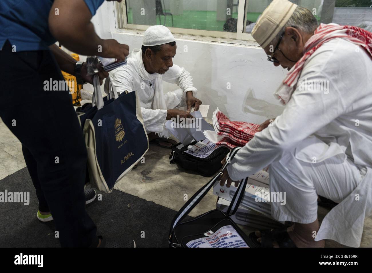 Hajj pilgrims check passport and documents before leaving to the ...
