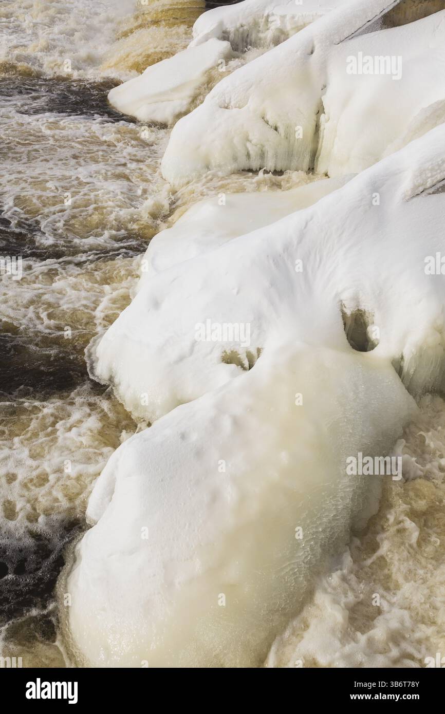 Packed snow with ice and strong water current released through water ...