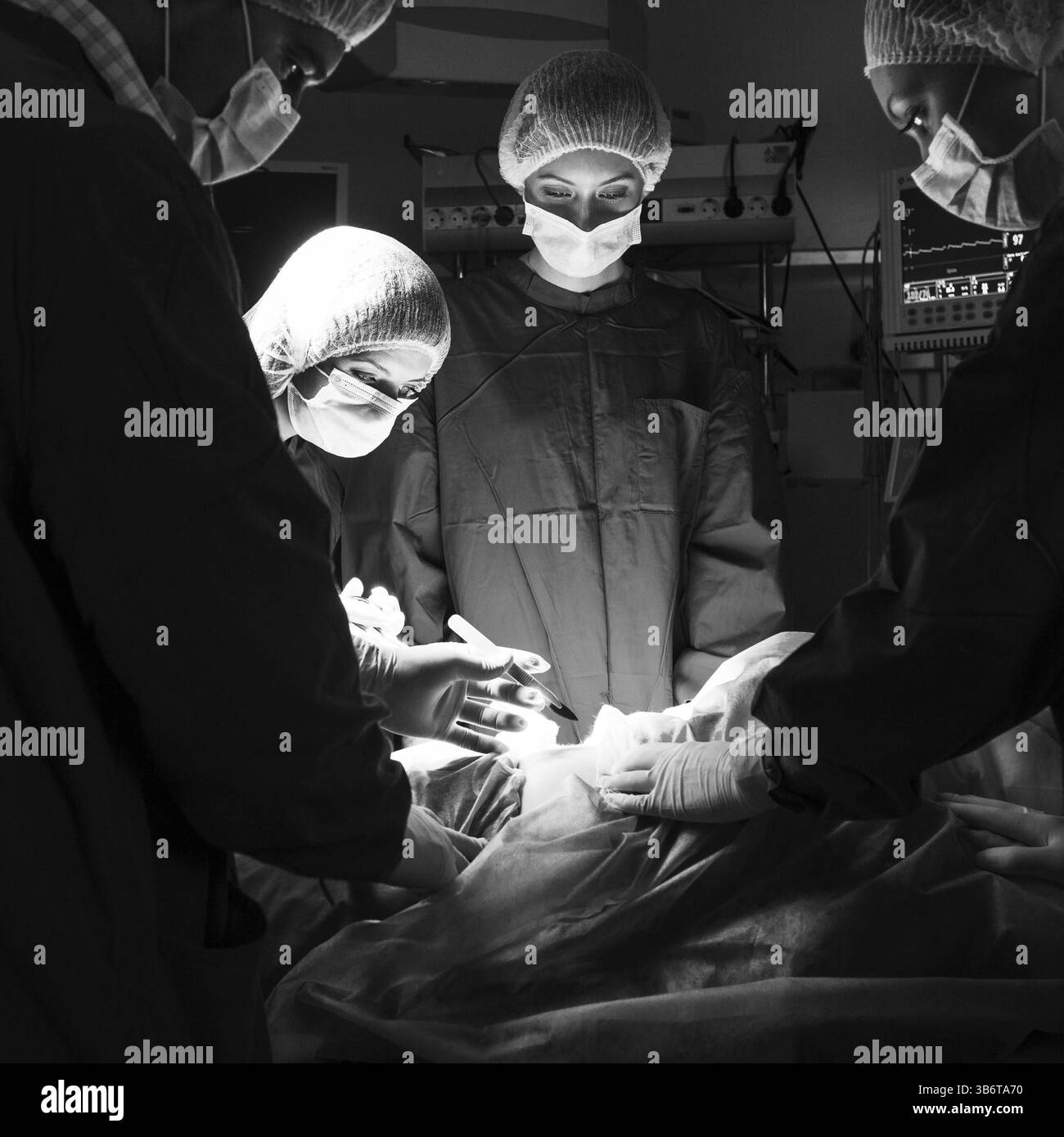 Surgery team operating in a surgical room Stock Photo - Alamy