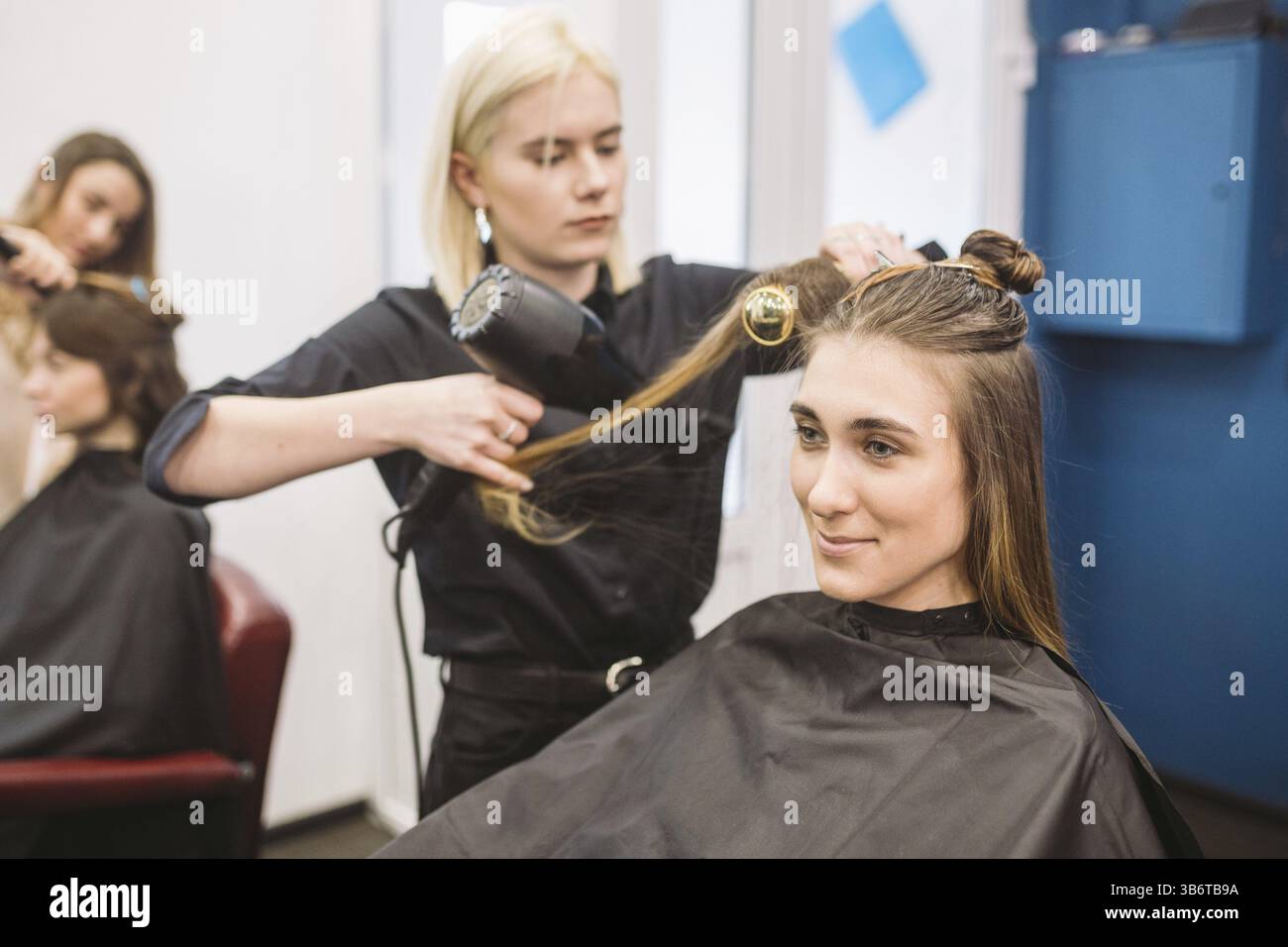 Portrait of happy woman at the hair salon. Professional hair styling ...