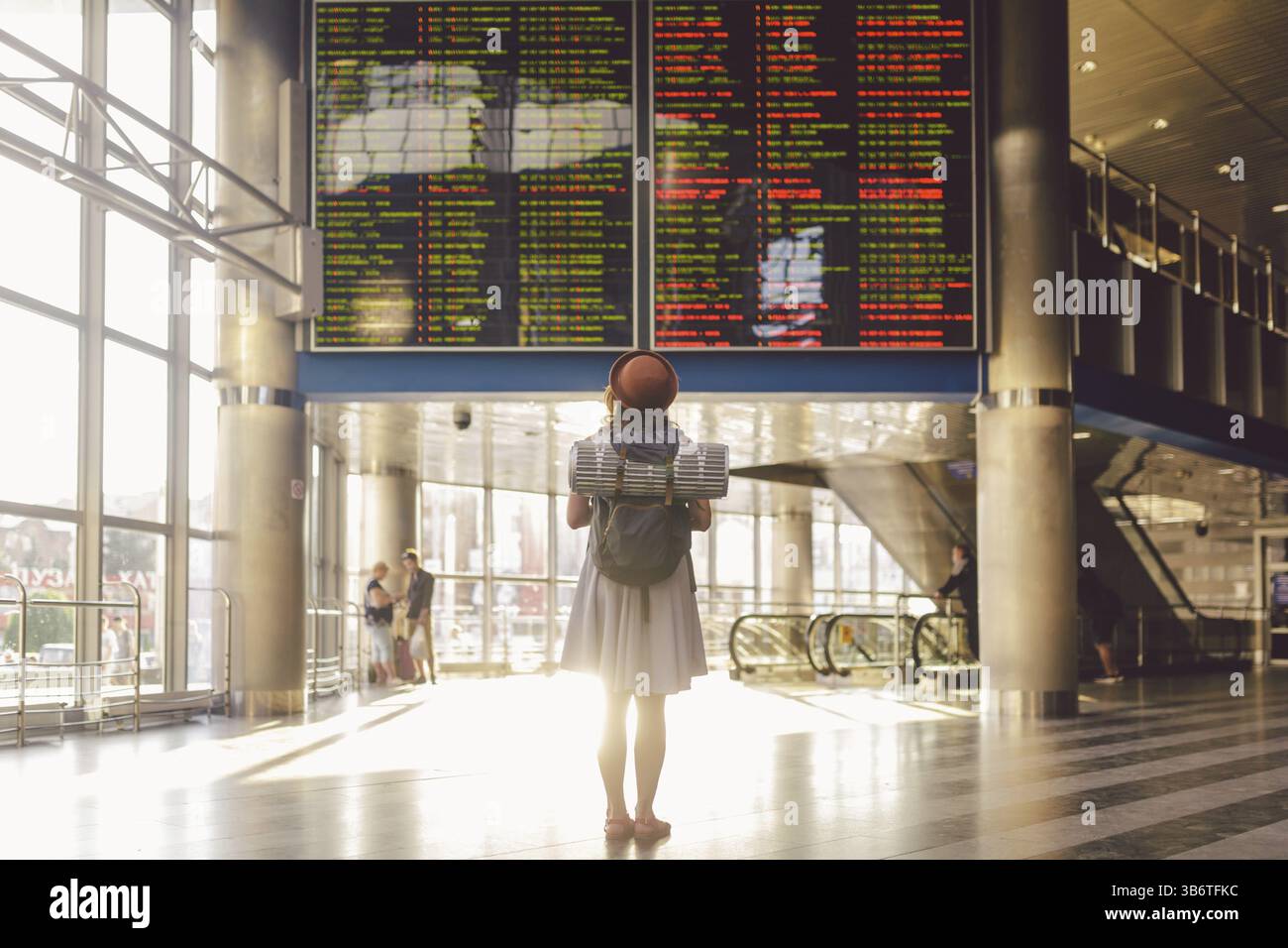 Theme travel public transport. young woman standing with back in dress ...