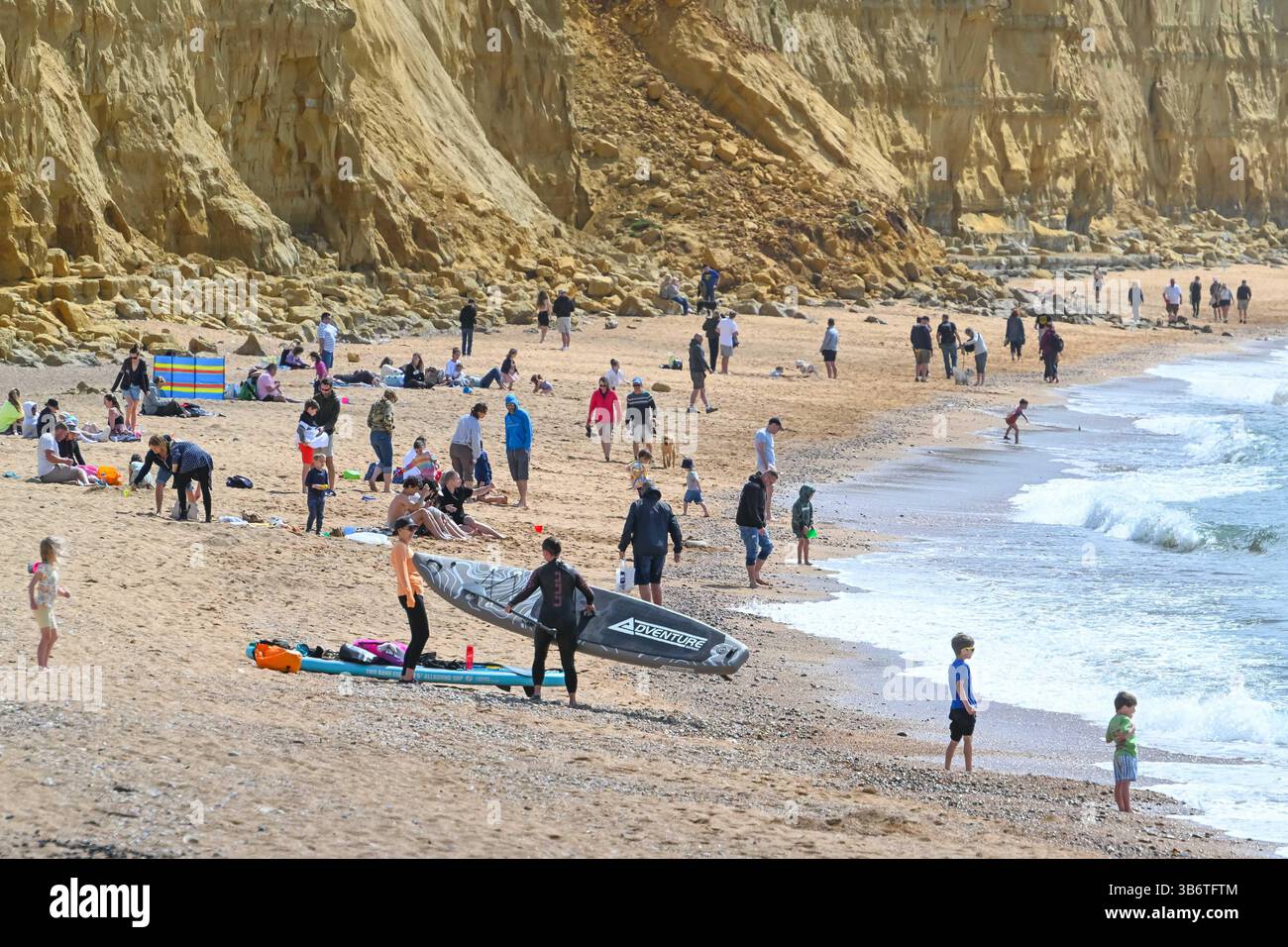 West Bay, Dorset, UK. 4th May 2025. UK Weather. Beachgoers enjoying the ...