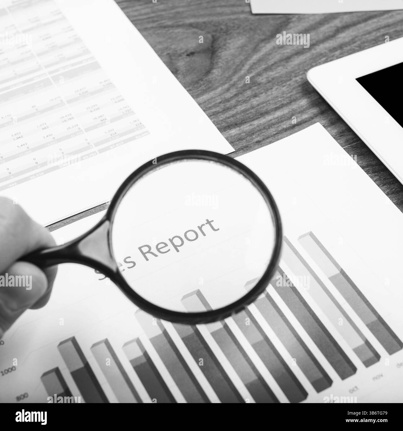 Businessman checking a graph with a magnifying glass, closeup Stock ...