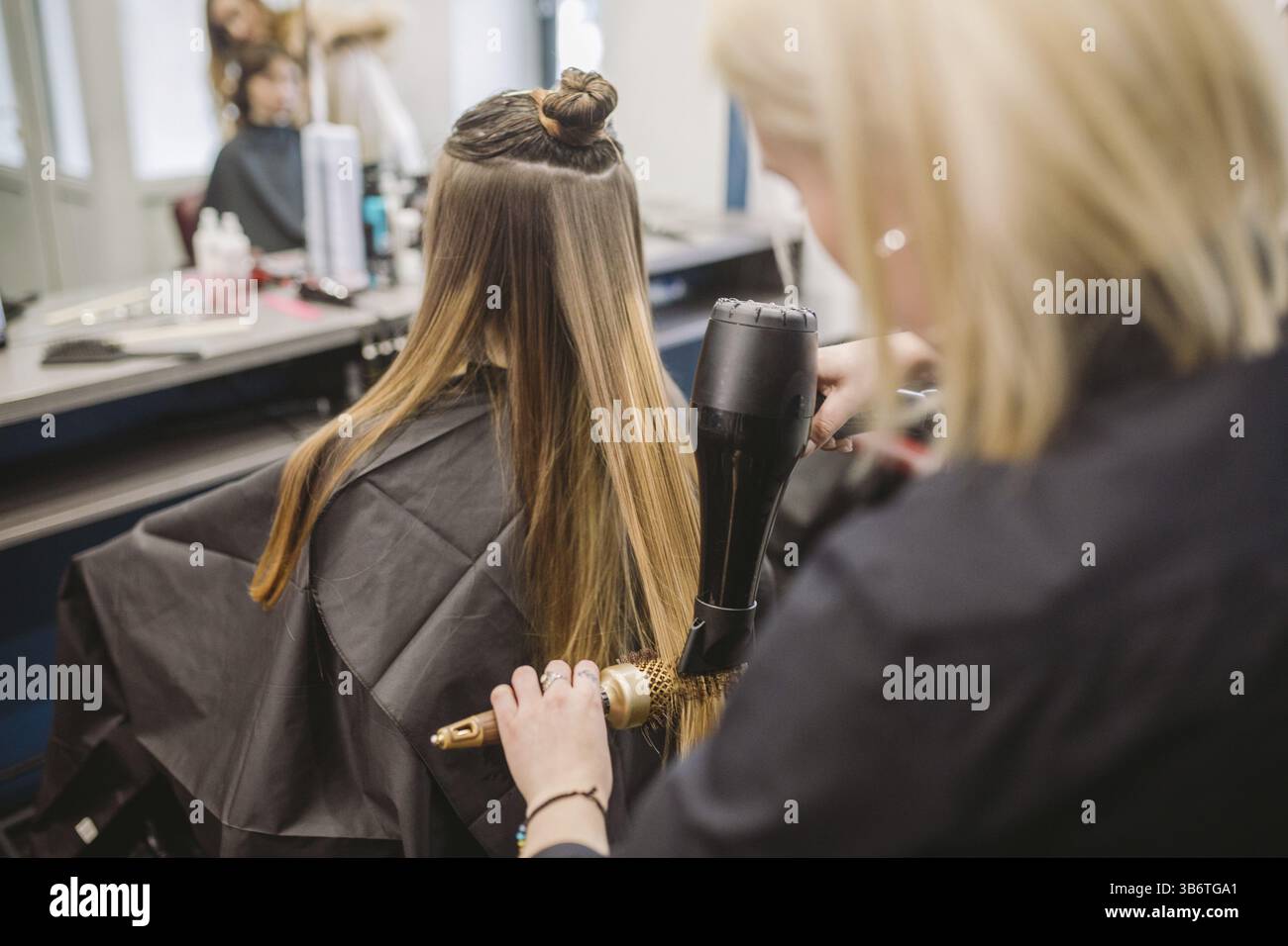 Portrait of happy woman at the hair salon. Professional hair styling ...