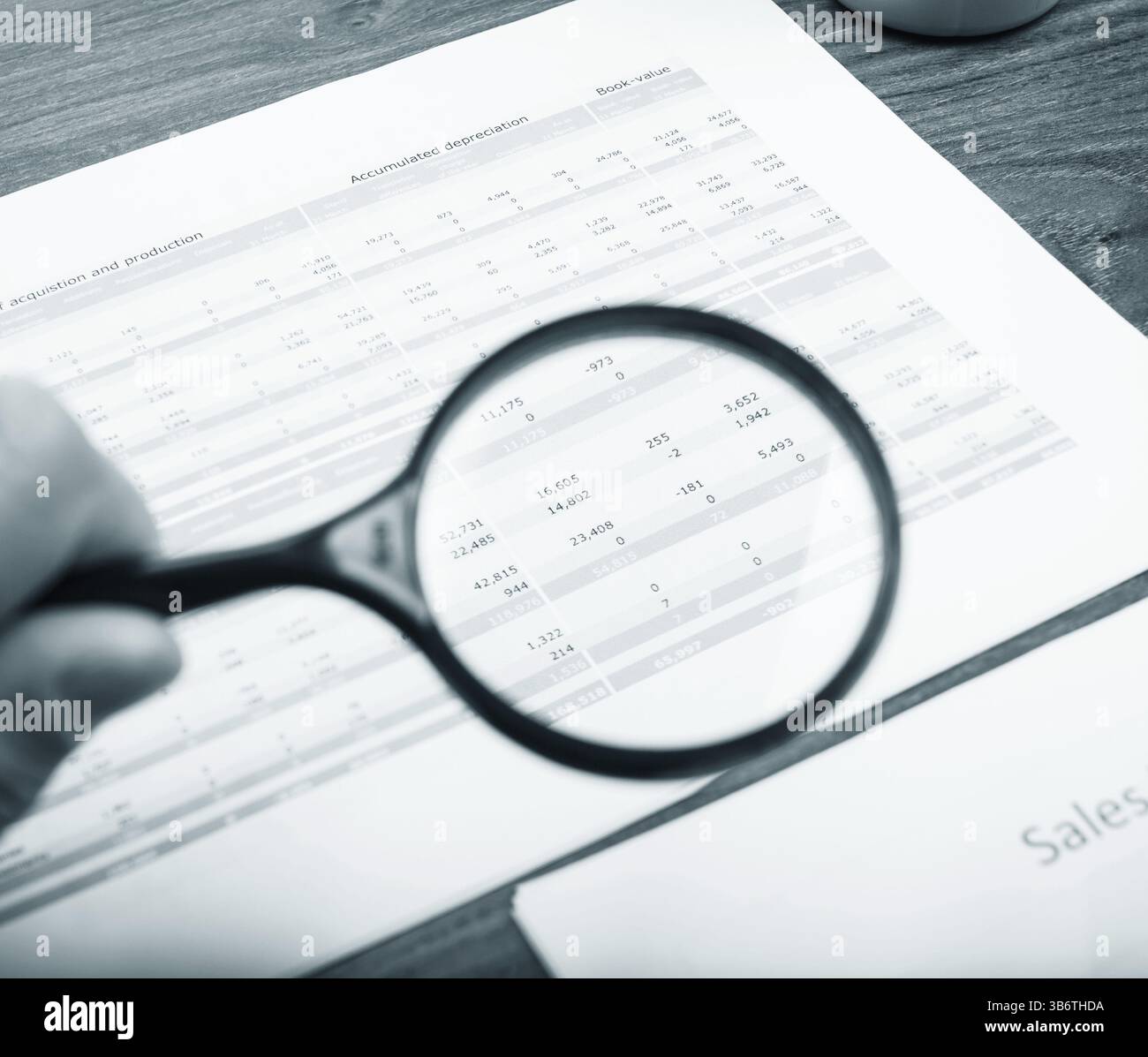 Businessman checking a graph with a magnifying glass, closeup Stock ...