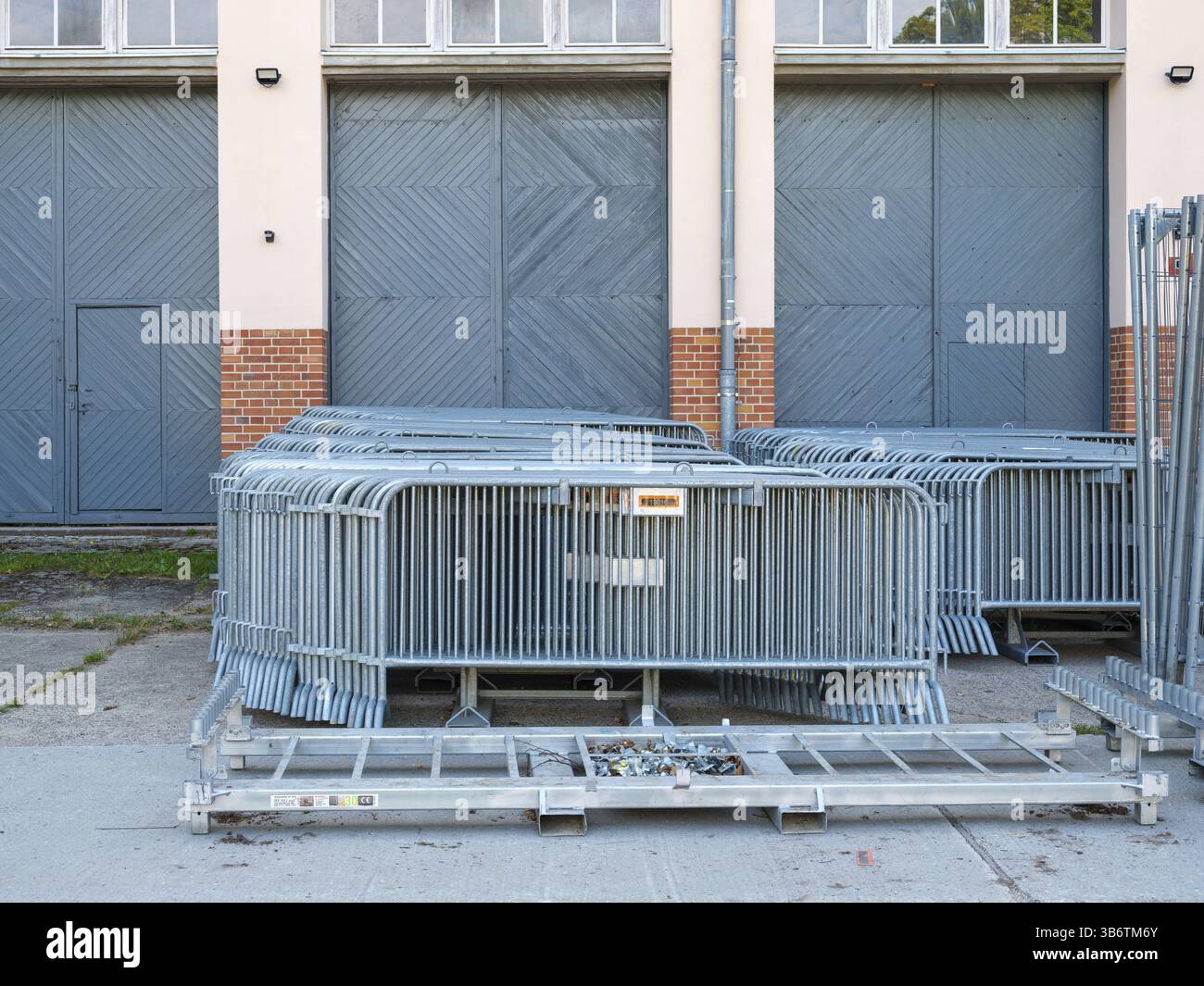 Stored police crowd control barriers made of steel stacked in front of ...