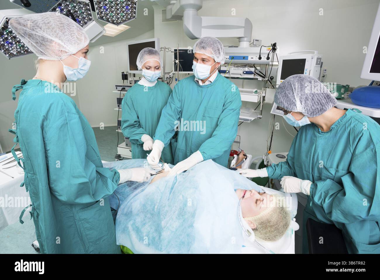 Surgery team operating in a surgical room Stock Photo - Alamy