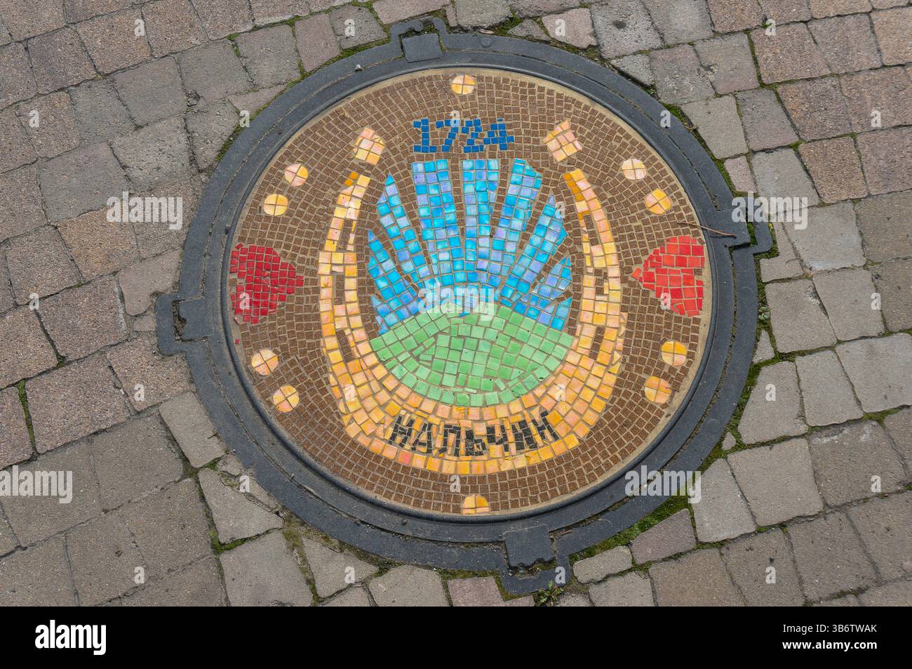 Manhole cover with coat of arms, mosaic. Nalchik, Russia Stock Photo ...