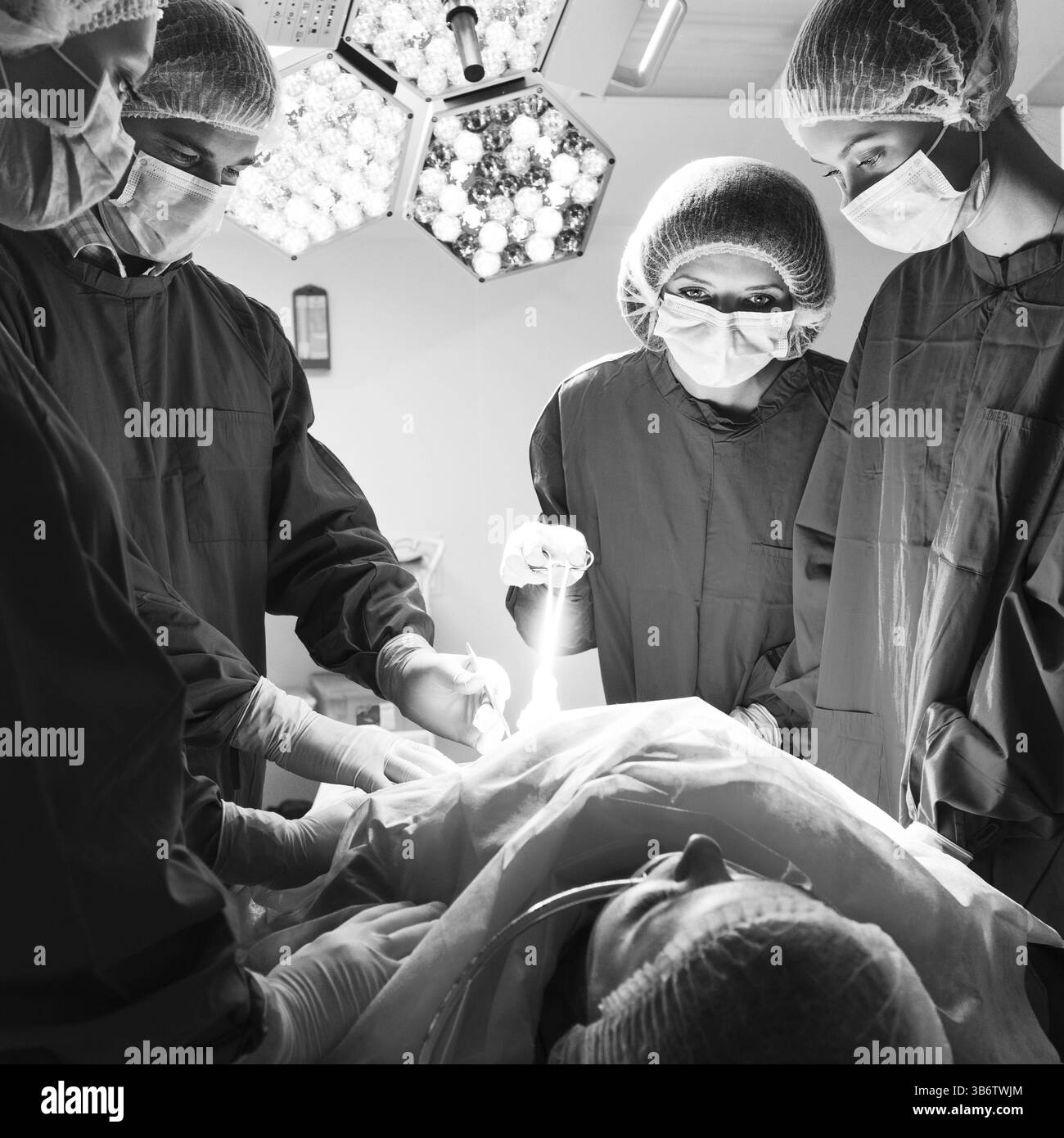 Surgery team operating in a surgical room Stock Photo - Alamy