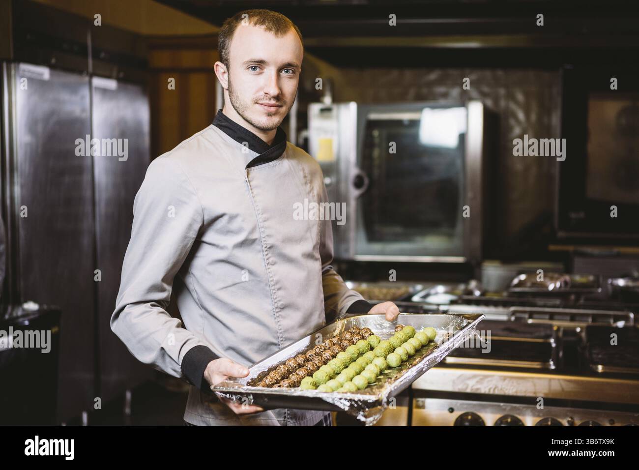 Subject profession and cooking pastry. Young caucasian male pastry chef ...