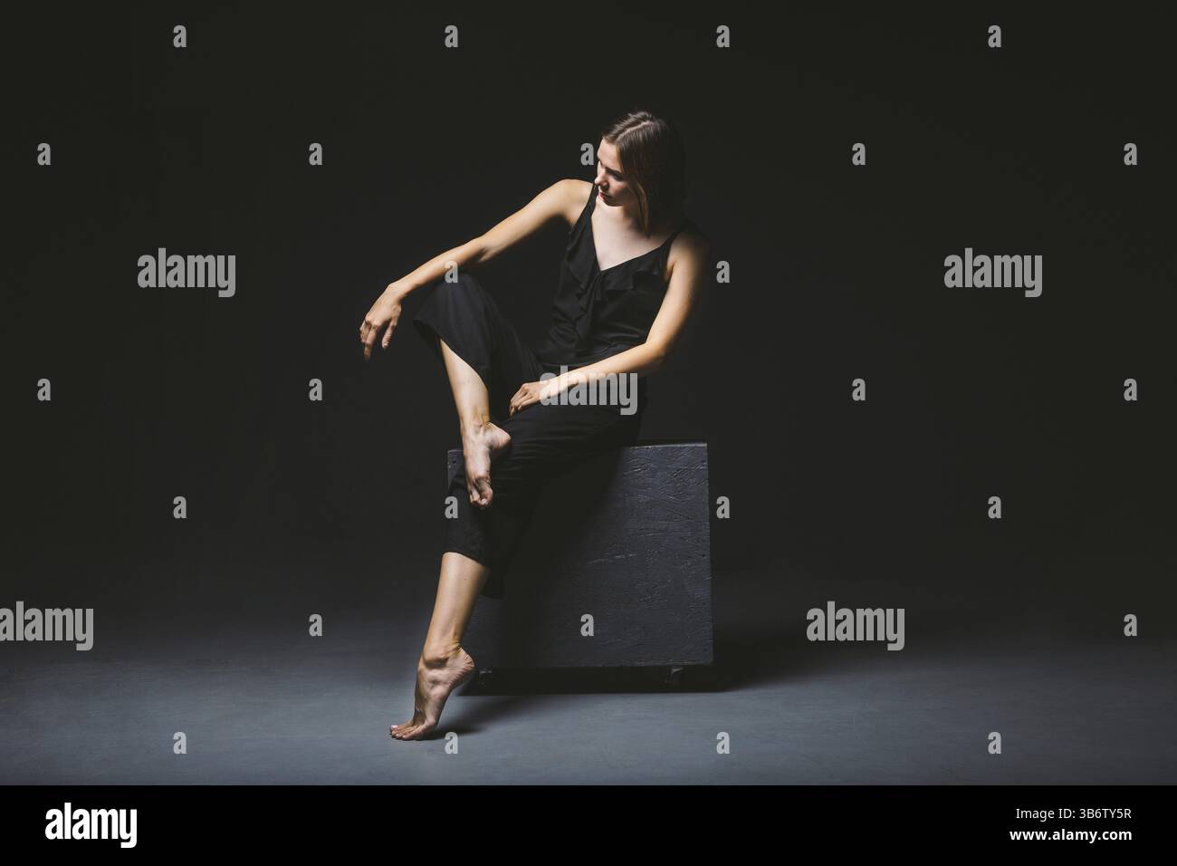 Social theme. young Caucasian woman in strange pose in dress posing on ...