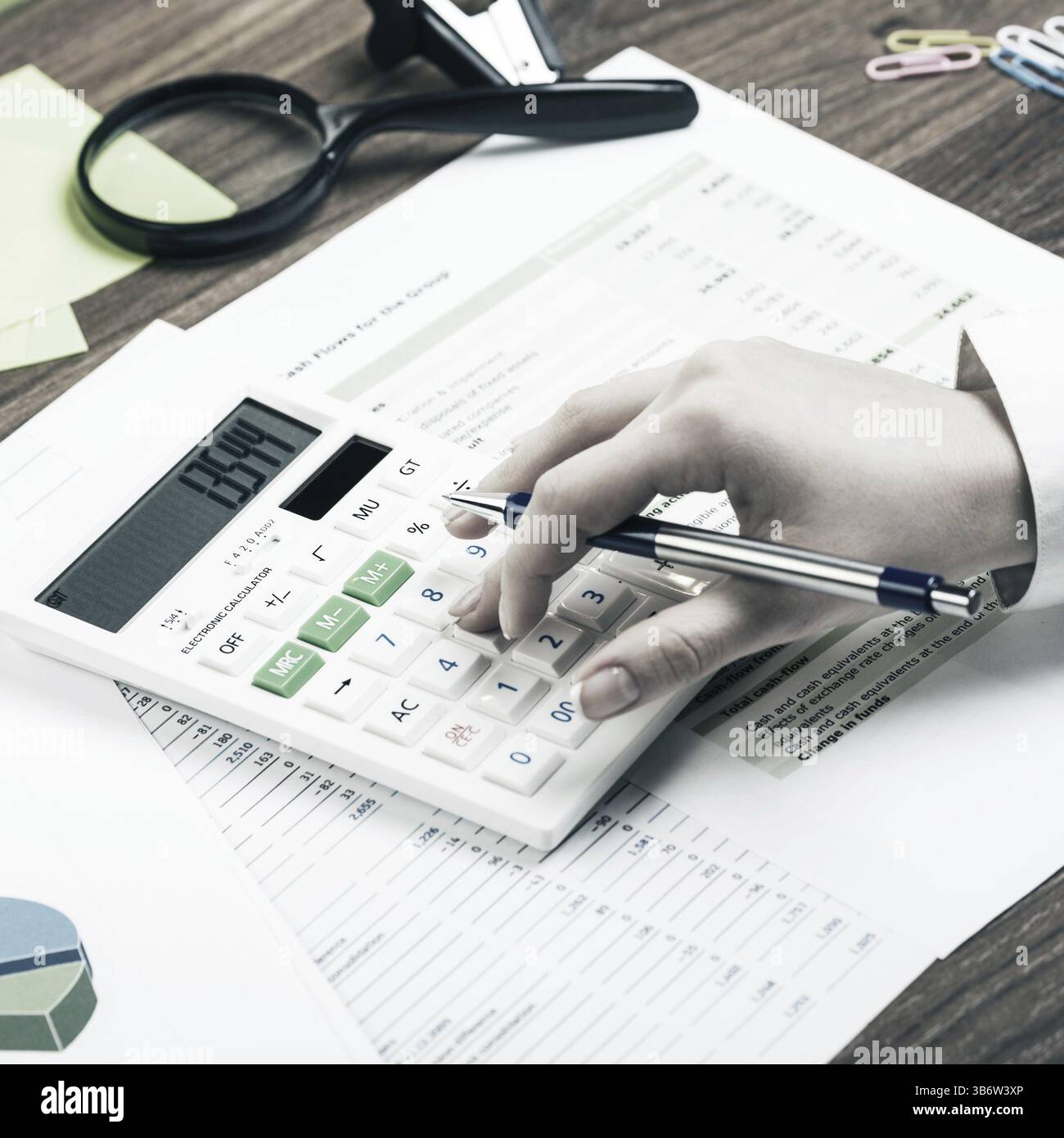 Close up of a female hand calculating, on the office desk Stock Photo ...