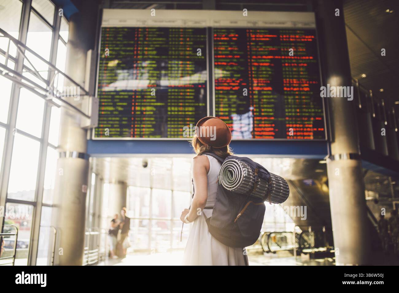 Theme travel public transport. young woman standing with back in dress ...
