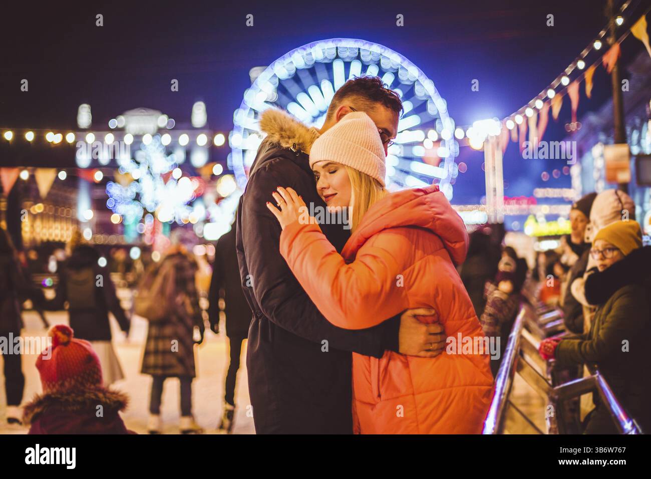 Beautiful Couple Ice Skating In City Centre. Young couple skating at a ...